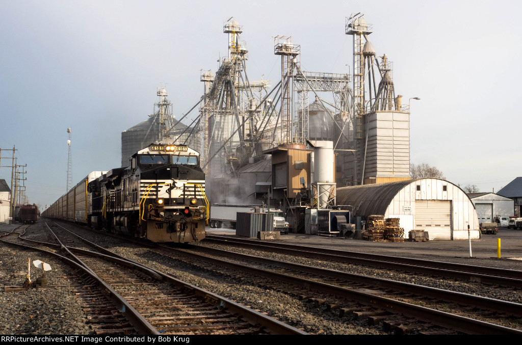 NS 4181 leads westbound auto racks past the Triple M Farms Feed Mill on the east side of Lebanon, PA